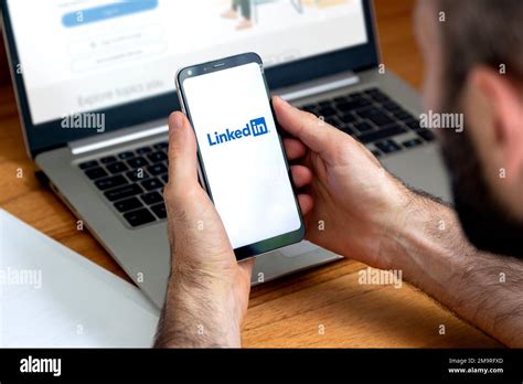 Linkedin App On Smartphone Screen Man Holding A Phone With A Professional And Business Oriented Linkedin App On Smartphone Screen Man Holding A Phone With A Professional And Business Oriented
