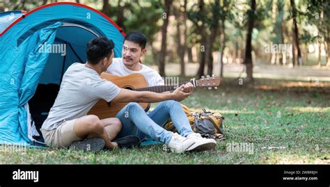 Lgbtqia Gay Couple Camping Together In Woods For Holidays And Relax On