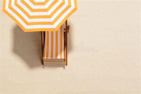 The Concept Of Summer Vacation Top View On A Sun Lounger Under An Umbrella On The Sandy Beach