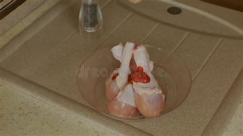 Women S Hands Sprinkle Chicken Legs Lying In A Glass Bowl With Spices
