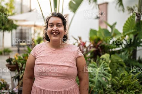 Portrait Of A Psychomotor Retardation Girl In Front Of Her House Stock