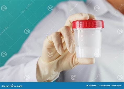 A Doctor S Gloved Hand Holding A Bottle Of A Container With A Sperm