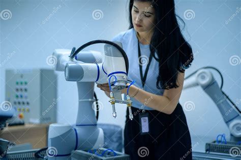 female robotics engineer working with programming and manipulating