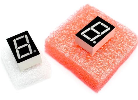 premium photo seven segment indicators inserted into a white and red foam on a white background