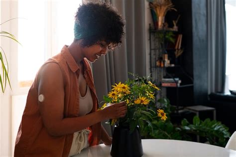 Free Photo Woman Wearing Glucose Patch Sensor While Watering Plants