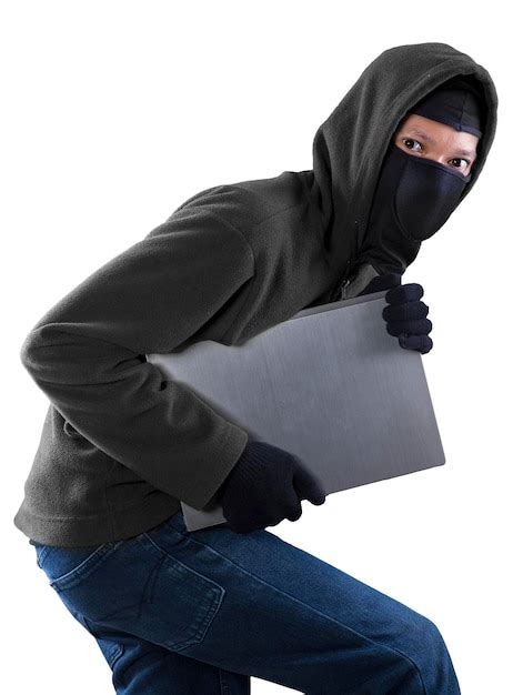 Premium Photo Thief Stealing A Laptop Computer