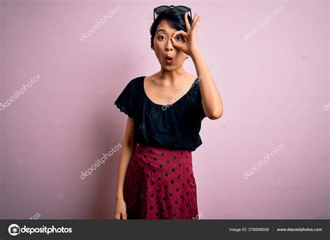 Young Beautiful Asian Girl Wearing Casual Dress Standing Isolated Pink