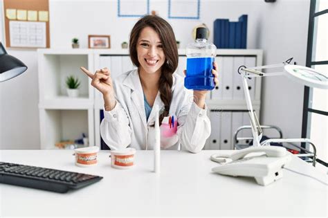 Young Dentist Woman Holding Mouthwash For Fresh Breath Smiling Happy