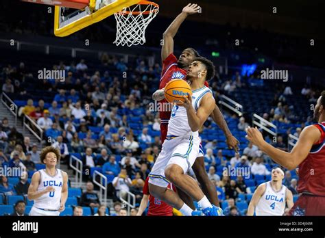 Ucla Guard Eric Freeny 8 Goes To The Basket While Defended By West Georgia Forward Xavier