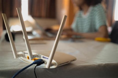 Premium Photo A Woman Is Working At Home Using A Modem Router Connecting The Internet To Her