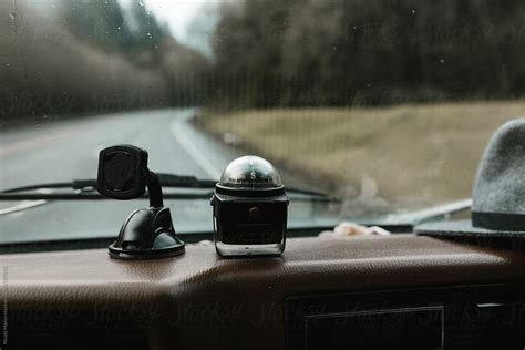 View Of Road Through Windshield With Compass On Dashboard Del