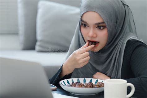 Cheerful Muslim Woman In Hijab Eating Dates Fruit And Enjoying A Break