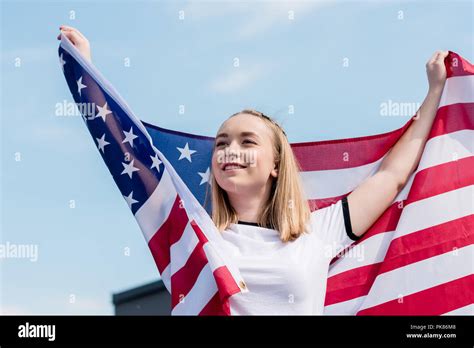 Happy Teen Girl With Usa Flag In Front Of Blue Sky Stock Photo Alamy