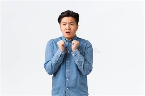 Portrait Of Timid And Insecure Young Asian Man Feeling Cornered Or