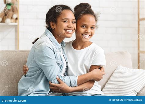 Two Lovely African American Sisters Hugging At Home Stock Image Image Of Love Affectionate