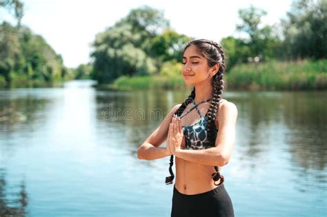 Young Indian Woman Doing Cobra Pose From Yoga Lying On Pier Stock Image