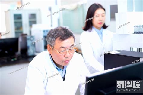 People Analysis Experimental Data By Using Computer In Lab Stock Photo