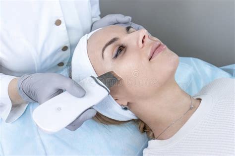 A Dermatologist Does An Ultrasound Facial Peeling For A Beautiful Woman