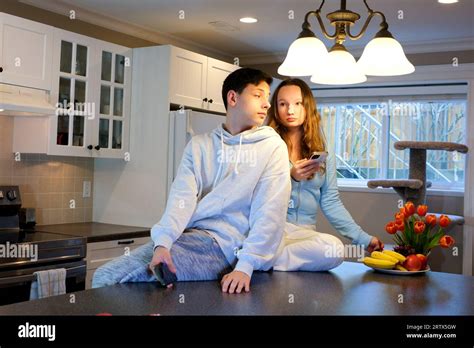 Romantic Smiling Couple Young Guy And Girl Sit On Warm Kitchen Floor
