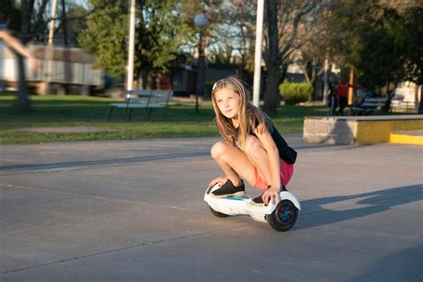 Premium Photo Portrait Of Girl Riding Hoverboard