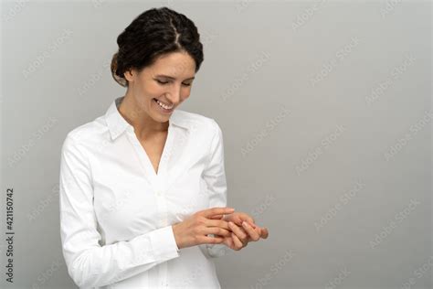 Foto De Shy Smiling Employee Or Business Woman With Perfect Teeth Smile Hides A Glance Isolated