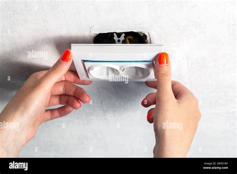 The Girl Is Trying To Insert A Torn Out Socket From The Socket Due To