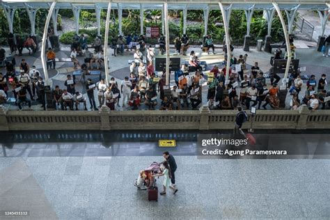 Foreign Tourists Push A Trolly Which Contain Of Luggages As They