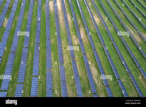 Aerial View Of Big Sustainable Electric Power Plant With Many Rows Of Solar Photovoltaic Panels