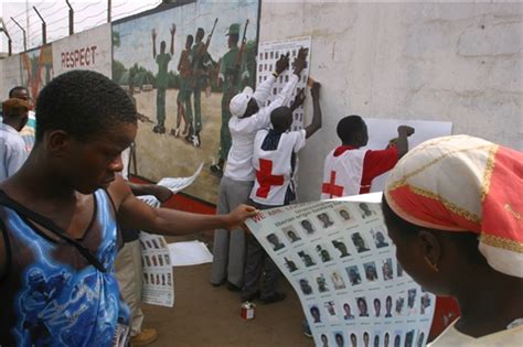 Monrovia In Front Of The Icrc Delegation Hanging Of Tracing Posters By Liberian Red Cross