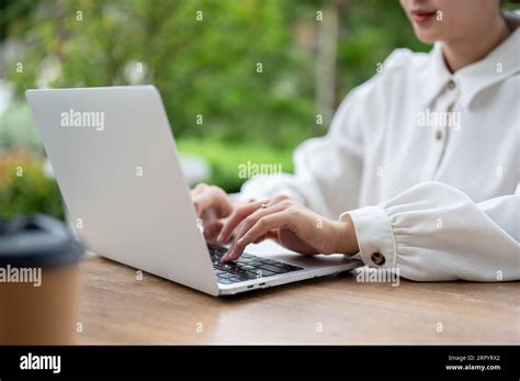 Close Up Image Of A Beautiful Asian Woman Typing On Laptop Keyboard Working On Her Laptop At A