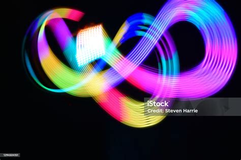 Multi Colored Light Steaks From A Rectangular Led Light Purple And Blue