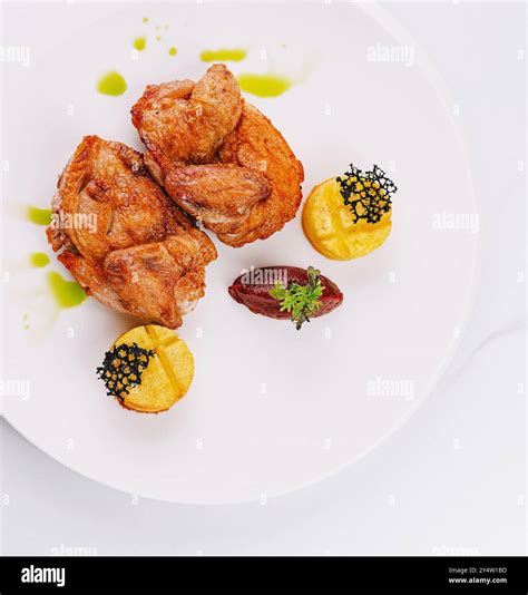 Elegant Plating Of Fried Chicken Topped With Caviar Served Alongside
