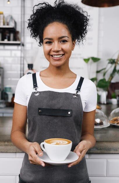 Premium Photo Portrait Of Smiling Woman Holding Coffee In Restaurant