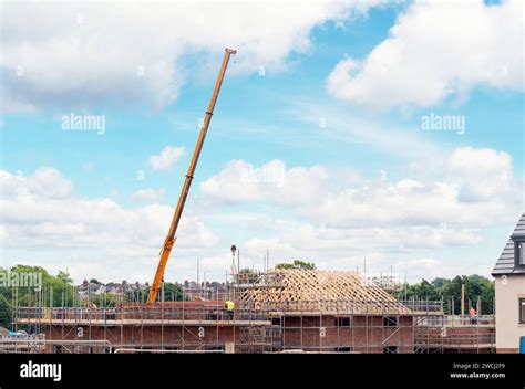 Mobile Crane At Building Site Lifting Joist For New House Roof