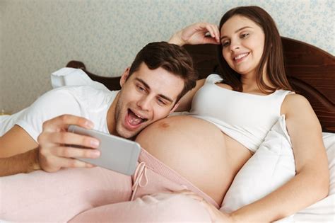 Free Photo Joyful Young Pregnant Couple Taking Selfie