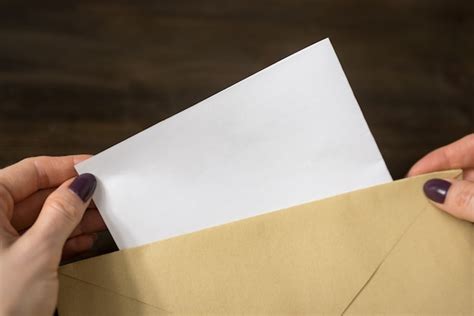 Premium Photo Female Hands Put A Letter In An Envelope