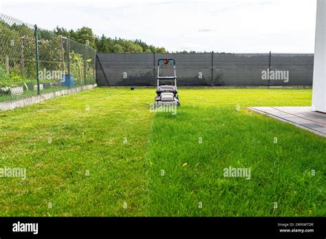 Mowing Grass With An Electric Powered Mower With A Cutting Width Of