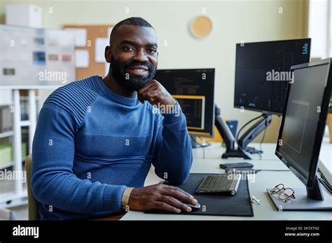 Portrait Of African American Man As Computer Programmer Smiling At
