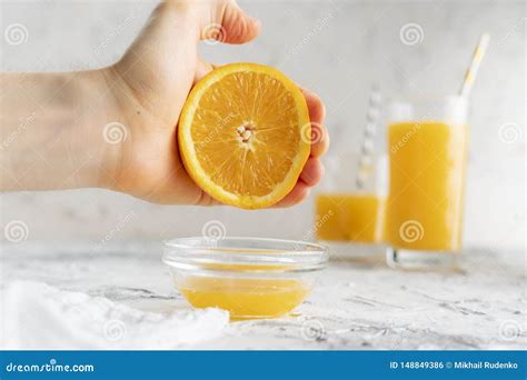 Person Squeeze Fresh Orange Juice with a Bare Hand, Healthy Drink in a Glasss Stock Photo ...