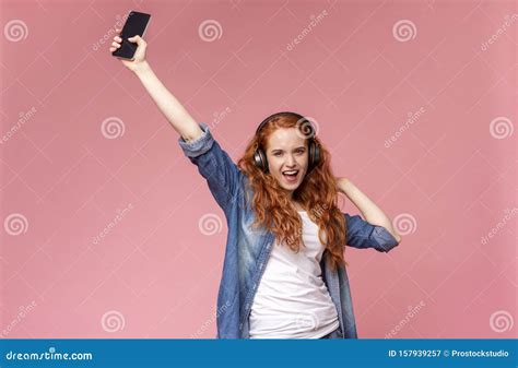 Beautiful Redhead Girl In Headphones Listening Music Online On Smartphone Stock Image Image Of