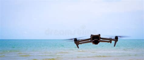 Drone With Digital Camera And Fast Rotating Propellers Flying Stock