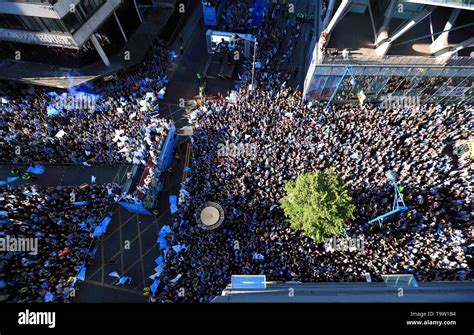 The Manchester City Players And Staff On The Buses Pass The Crowds Of