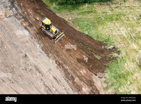 Yellow Tracked Bulldozer Performs Earthworks On Construction Site