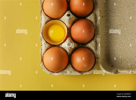 Fresh Brown Eggs And A Broken Egg With A Yolk In A Recycled Paper Eco