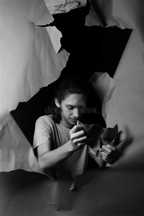 1 126 5 000a Man Peering Through A Hole In A Sheet Of Brown Paper