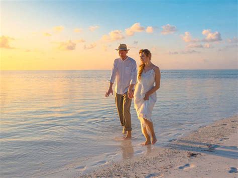 Download Romantic Sunset At Couple Beach Wallpaper
