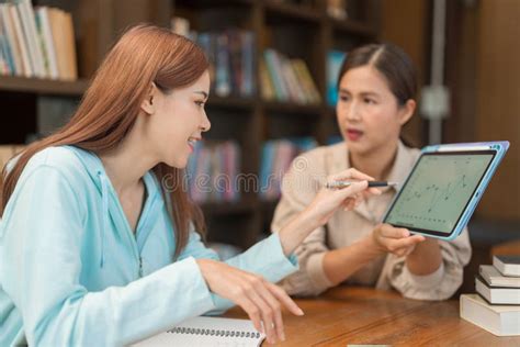 College Education Concept Teenage Girl Pointing Graph On Tablet To Asking Question With Tutor