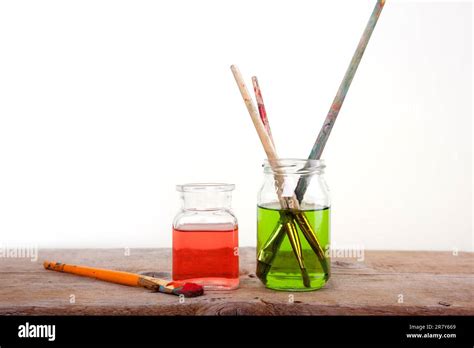 Glasses Cut Out With Watercolour And Brushes Against A White Background