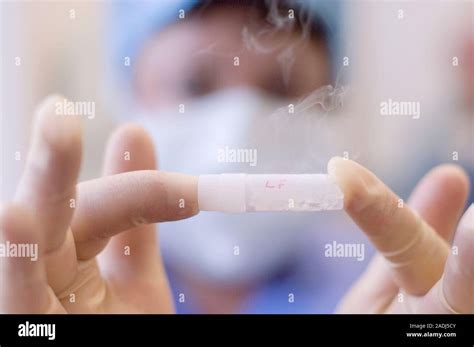 Biopsy Tissue Storage Surgeon Holding A Container That Contains A
