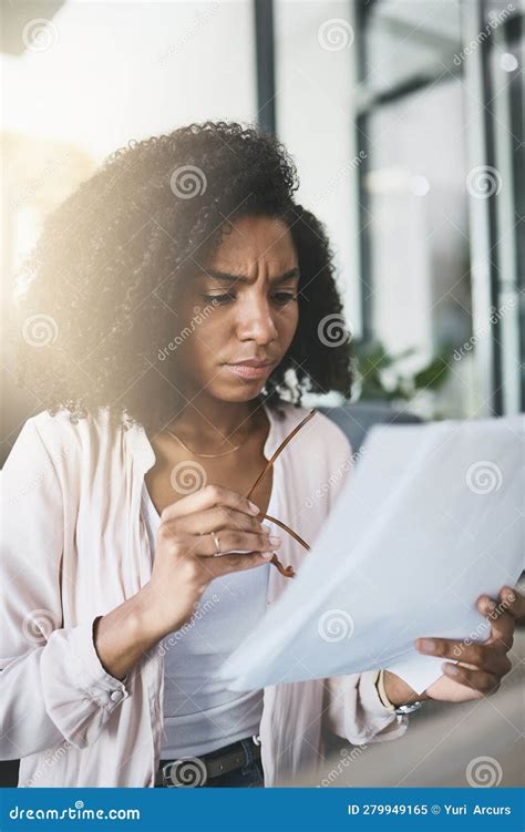 Something Doesnt Look Right An Attractive Young Woman Relaxing At Home